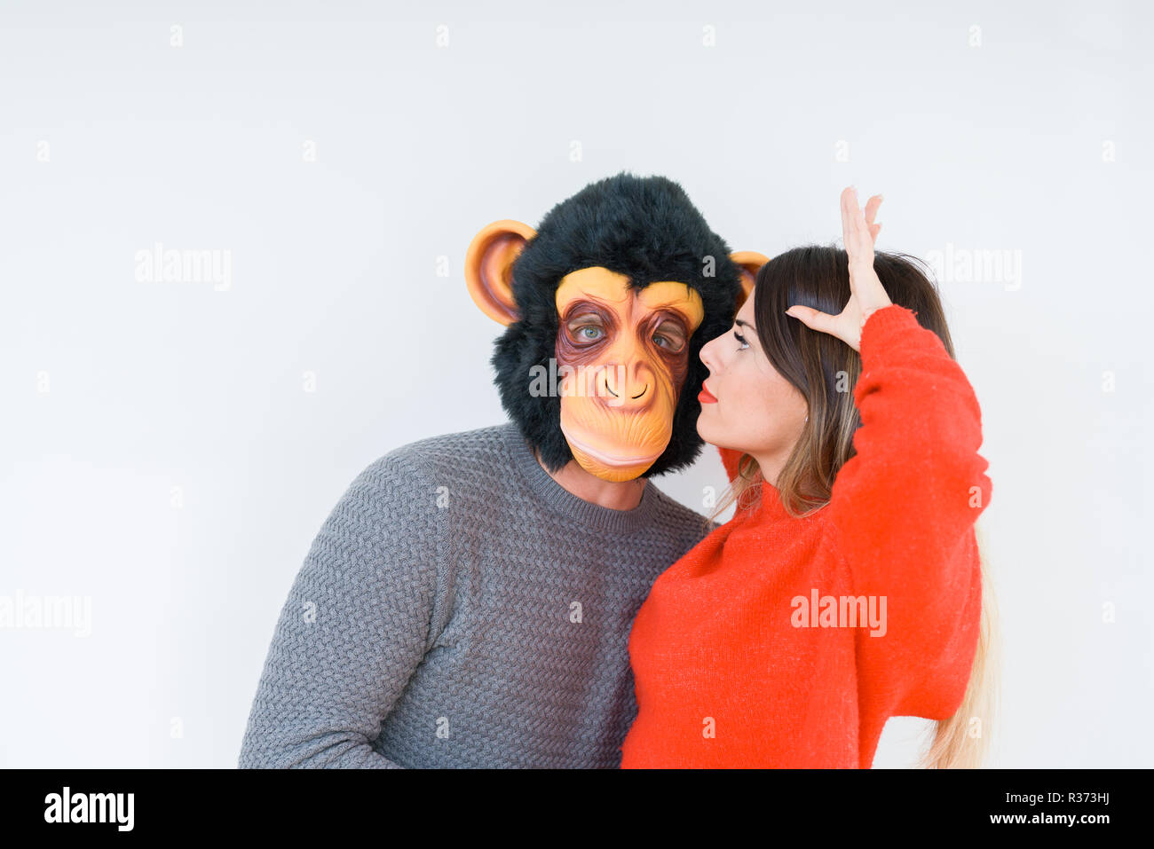 Funny young couple, boyfriend wearing monkey mask, crazy and idiot ...