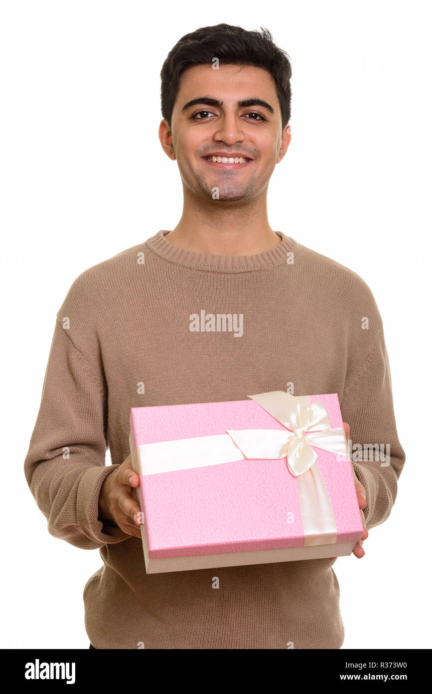 Young happy Persian man holding gift box ready for Valentine's d Stock ...