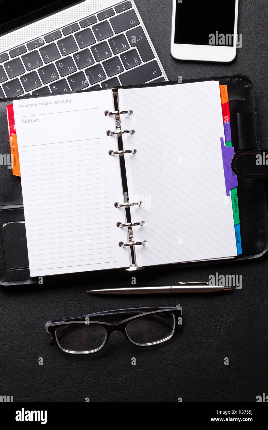 Office workplace table with notepad and laptop. Flat lay. Top view with ...