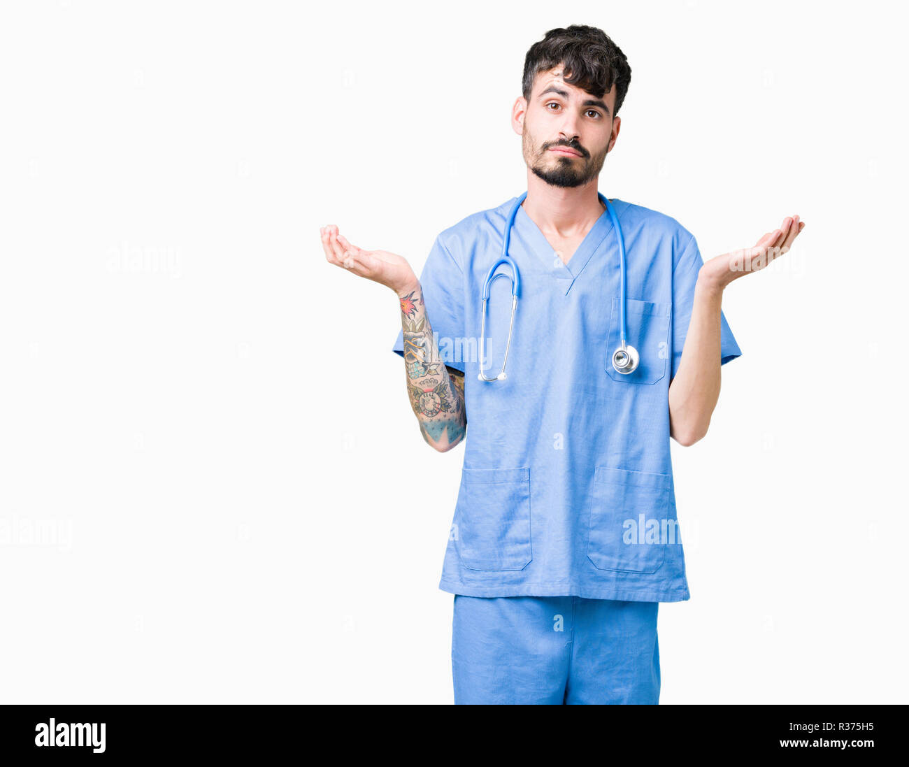 Young handsome nurse man wearing surgeon uniform over isolated ...