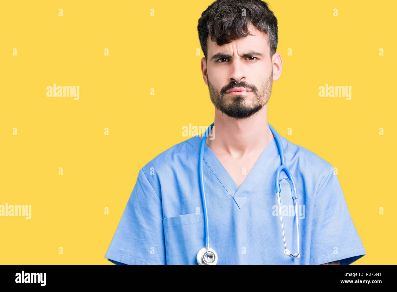 Young handsome nurse man wearing surgeon uniform over isolated ...