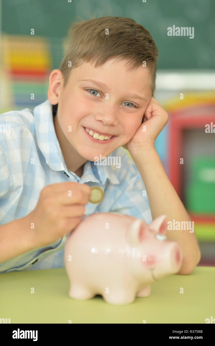 Portrait of a boy putting a coin Stock Photo - Alamy