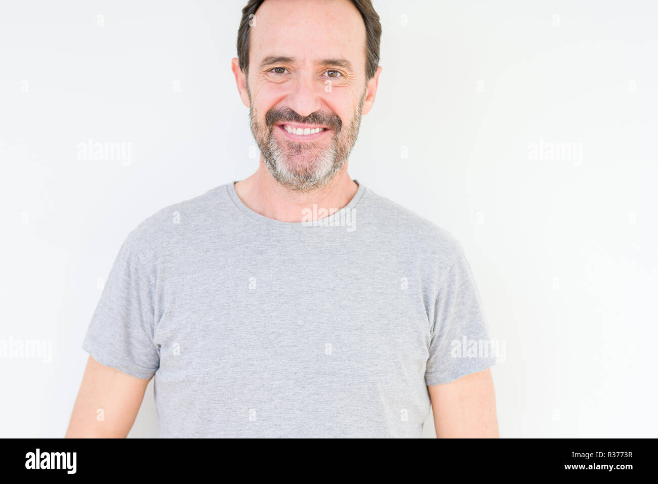 Handsome senior man over isolated background with a happy and cool ...