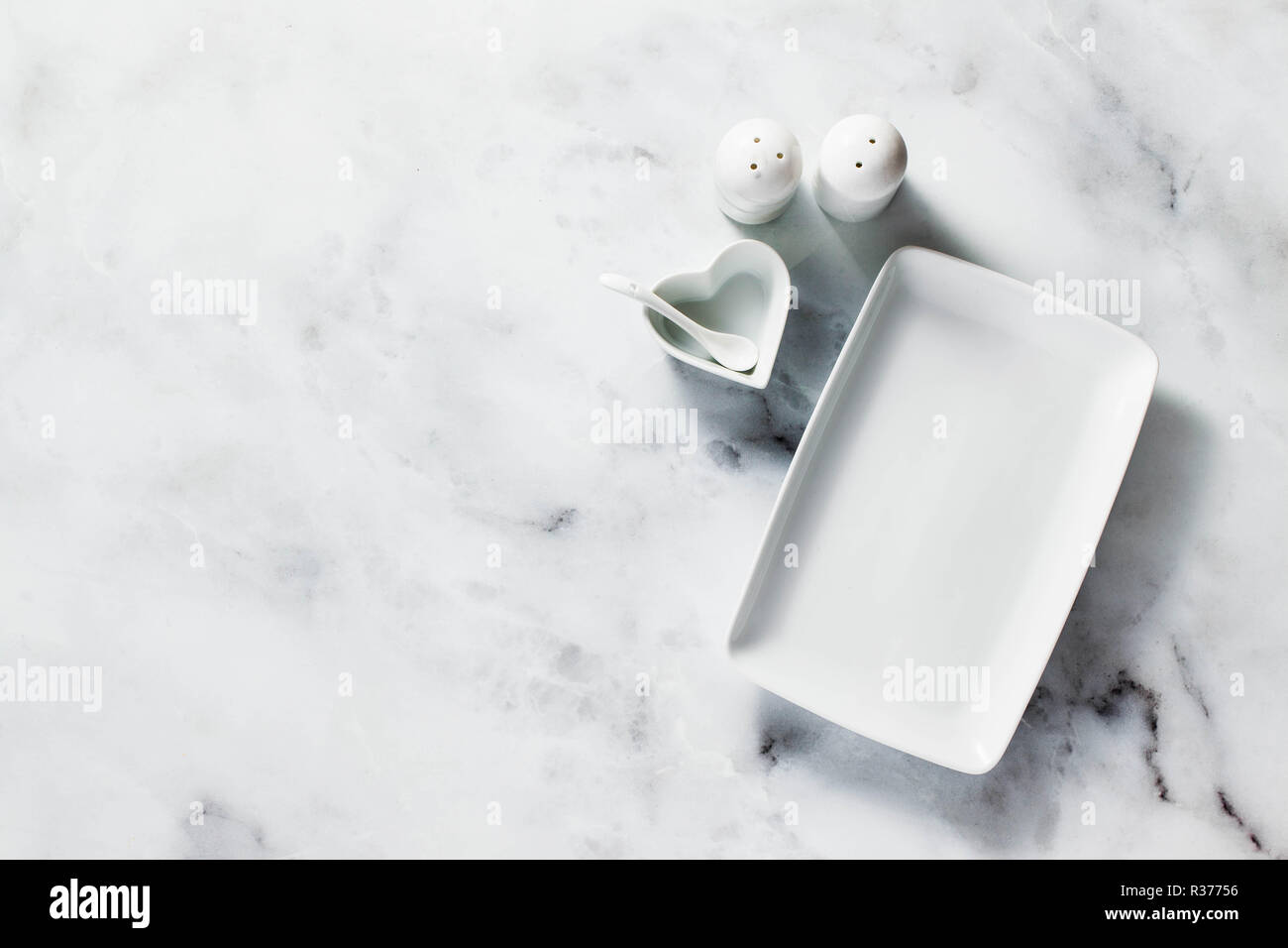 empty dishes on the marble table, copy space Stock Photo - Alamy