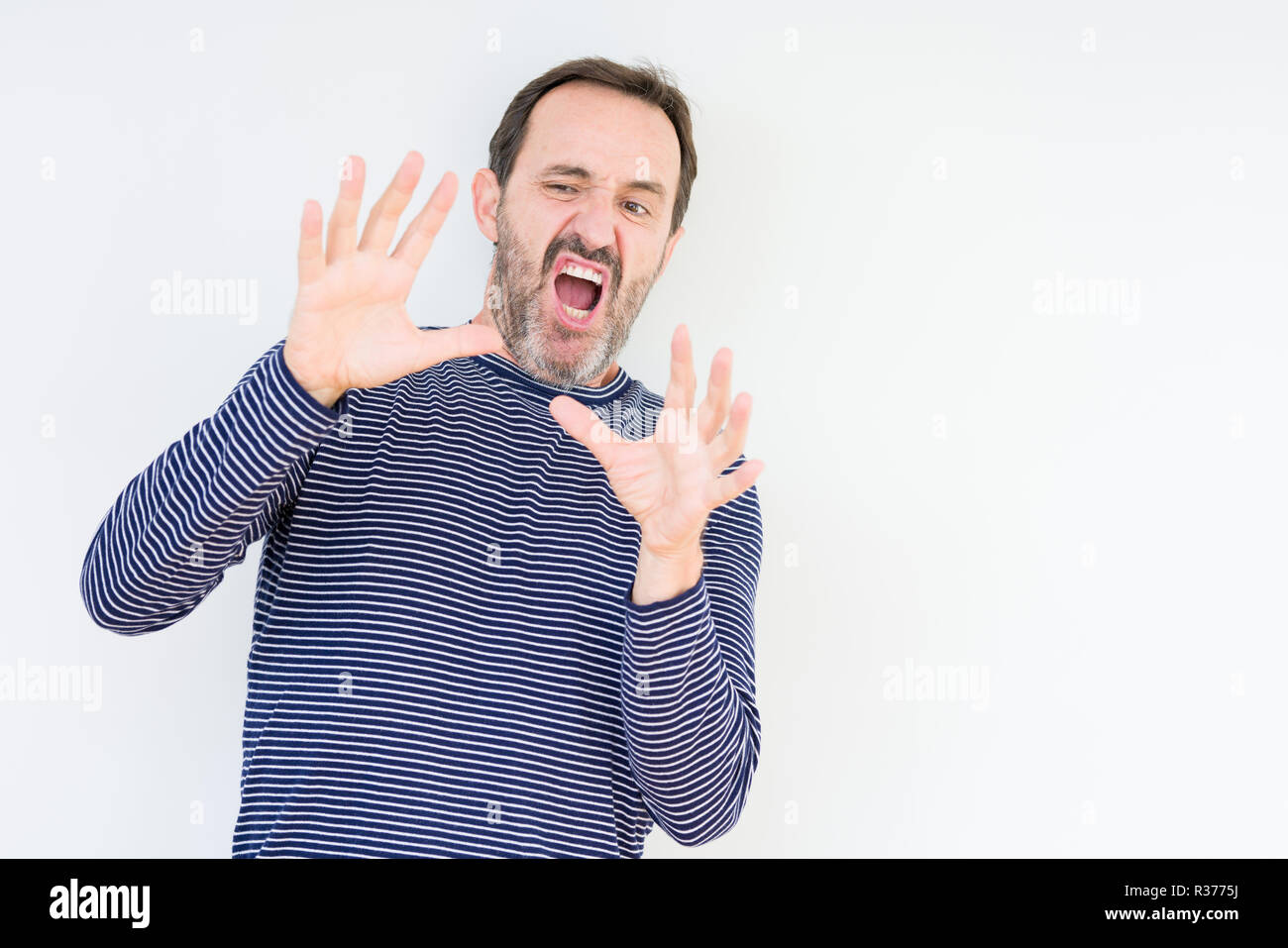 Handsome senior man over isolated background afraid and terrified with ...