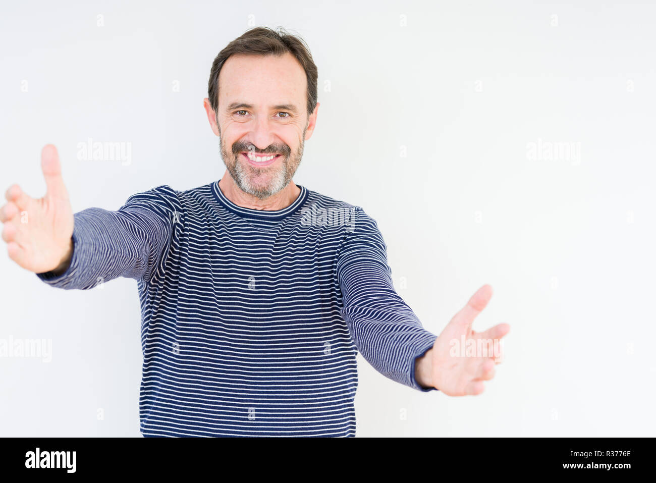Handsome senior man over isolated background looking at the camera ...