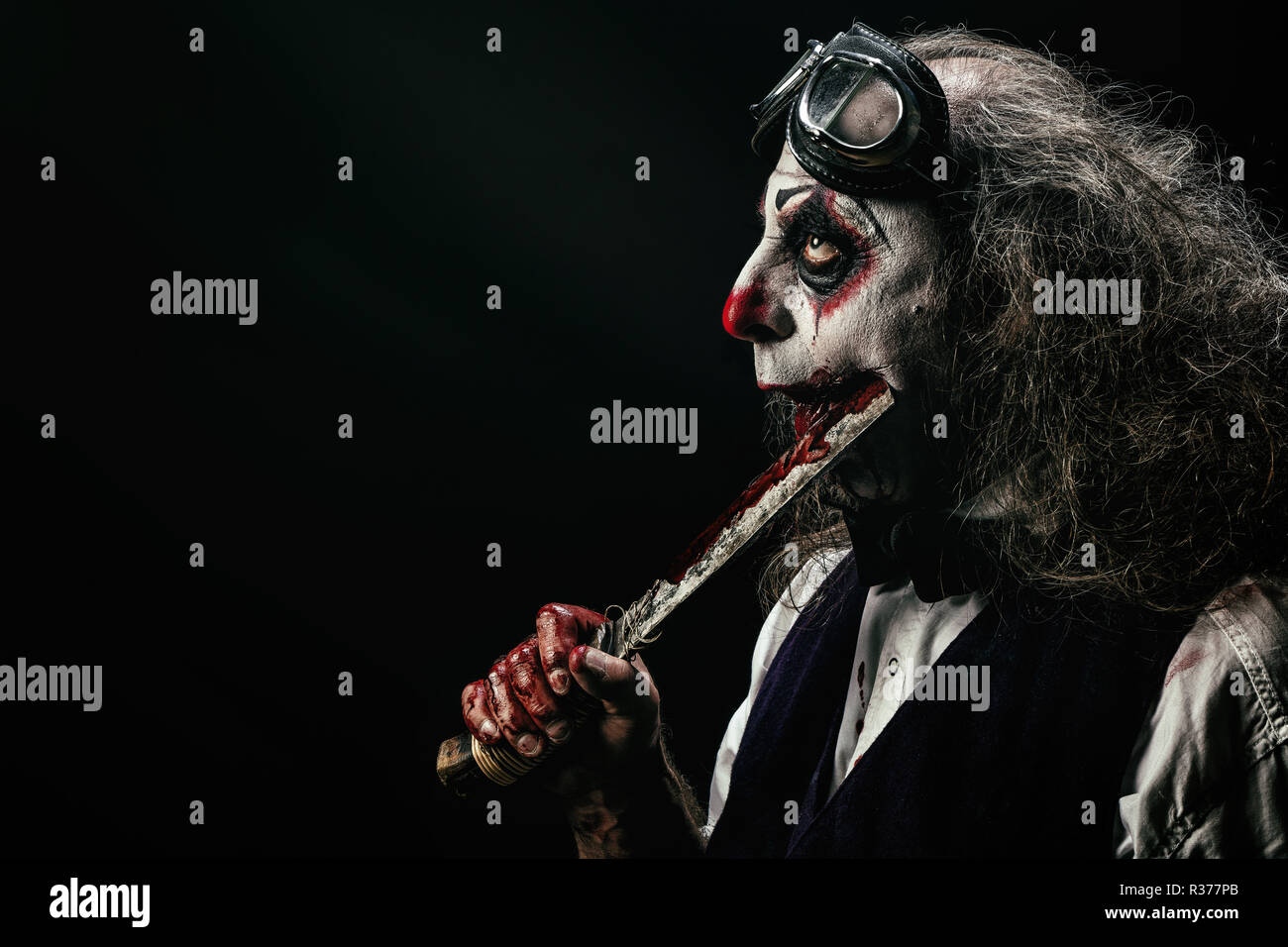Portrait of a sadistic clown, a bloody knife in his hand Stock Photo ...