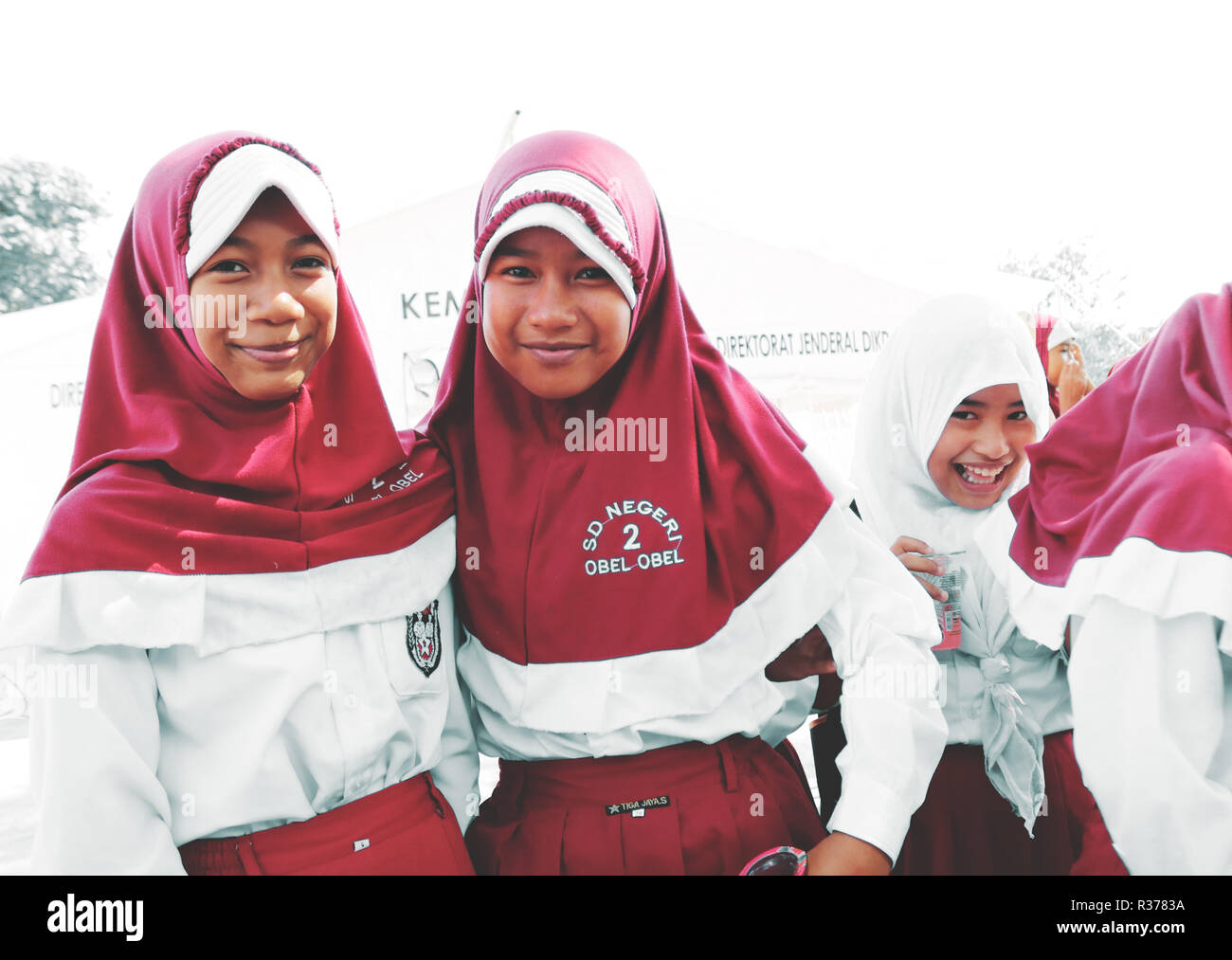 Three elementary school children from Indonesia are smiling Stock Photo ...