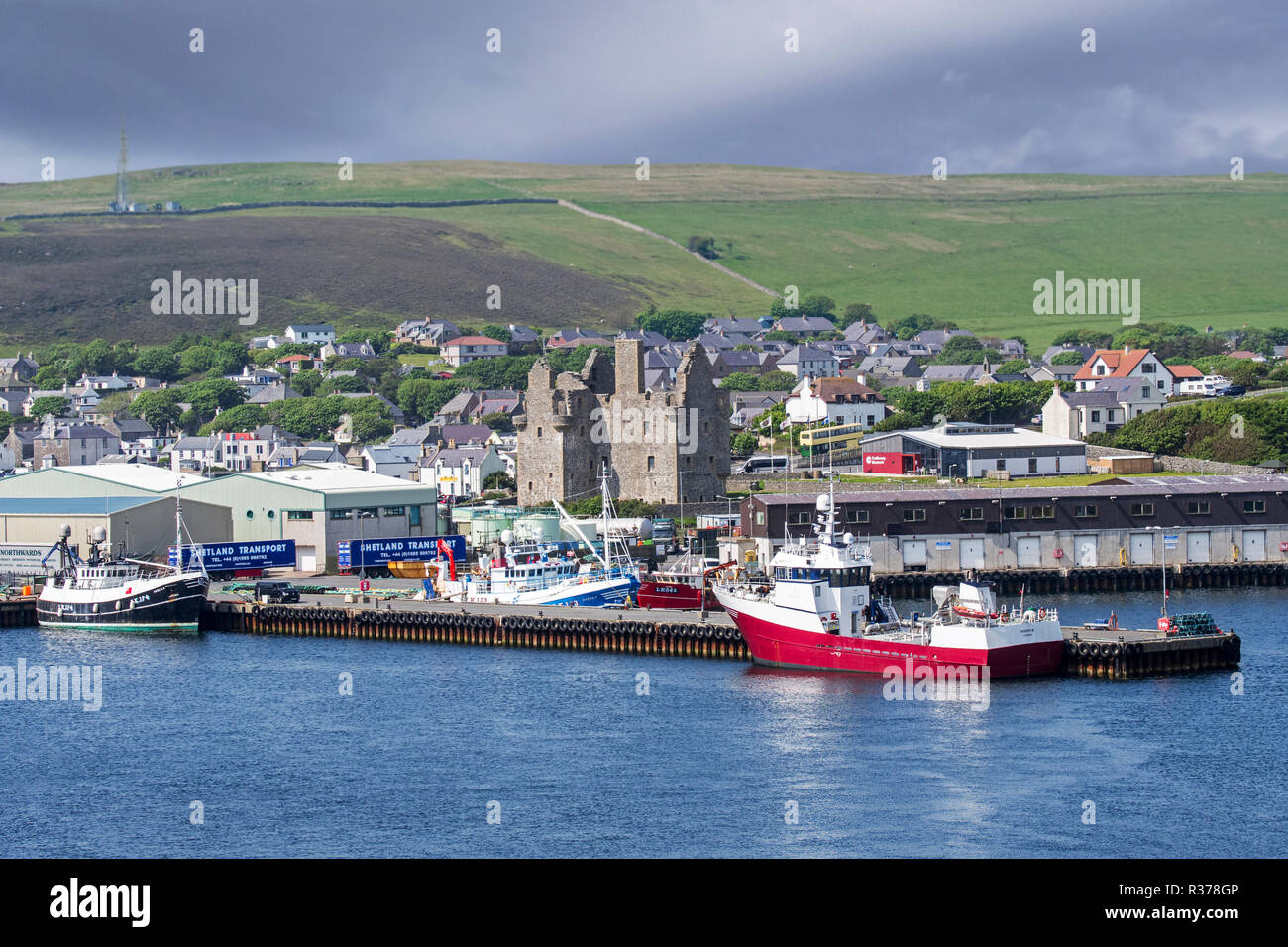 View over Scalloway Castle, museum and fishing boats in the harbour of ...