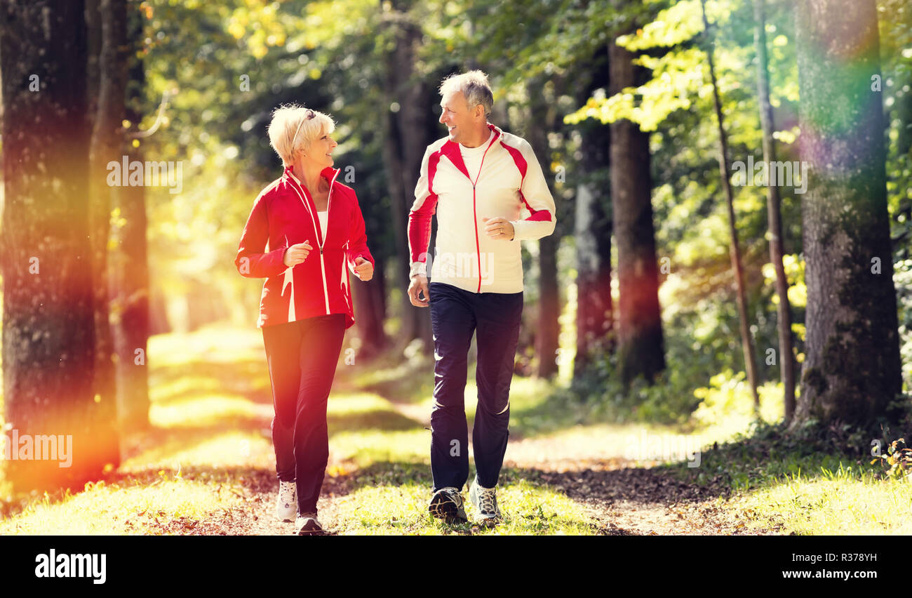 seniors jogging in forest Stock Photo - Alamy