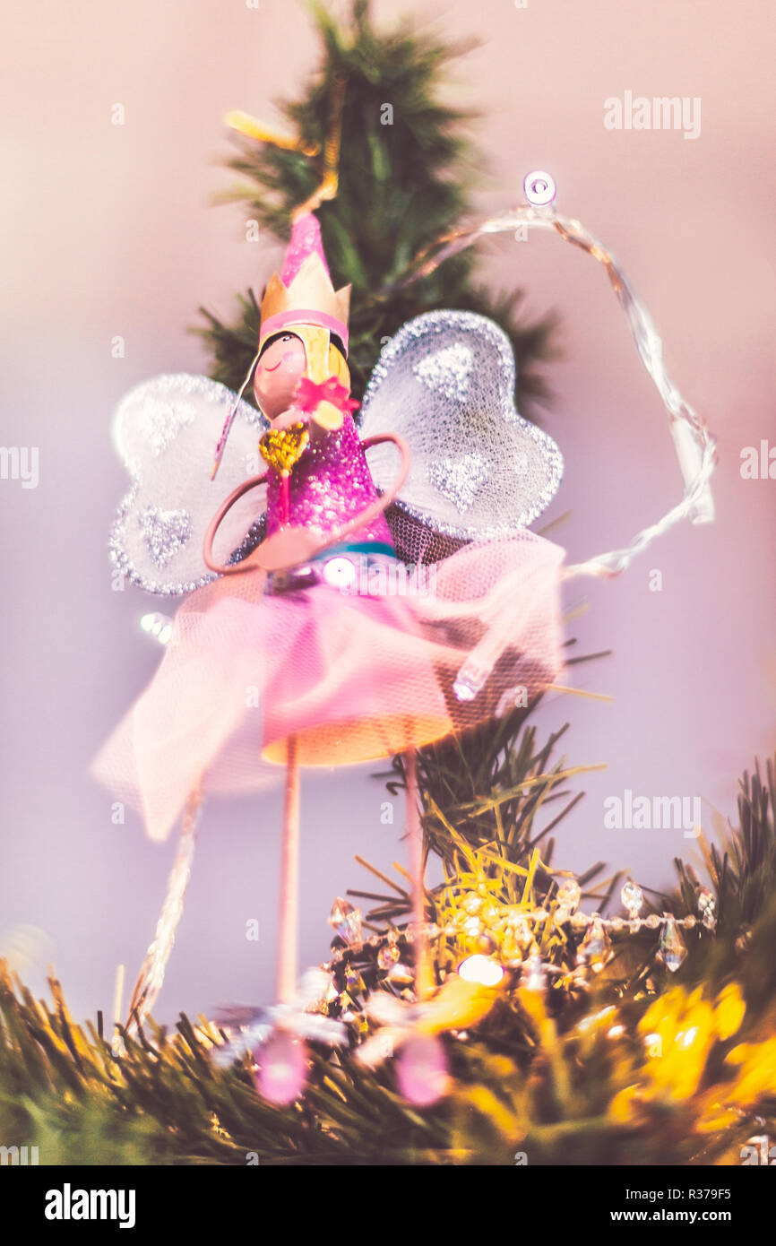 Pretty fairy angel decoration hanging from the top of a Christmas tree ...