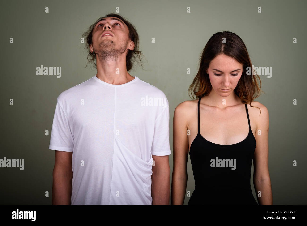 Young handsome man and young beautiful woman together against co Stock ...