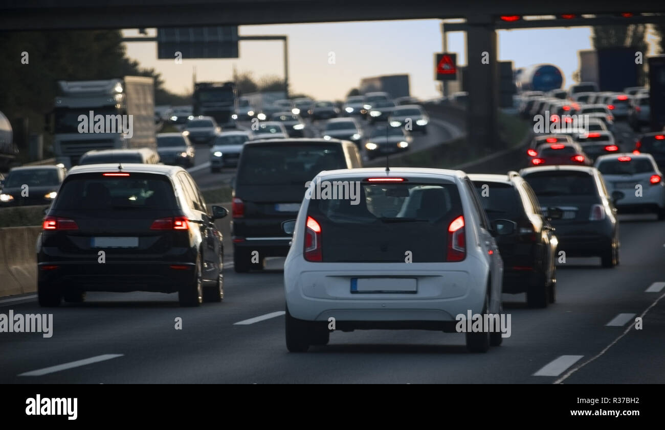 stream of cars, congestion and traffic jam at rush hour on the freeway ...