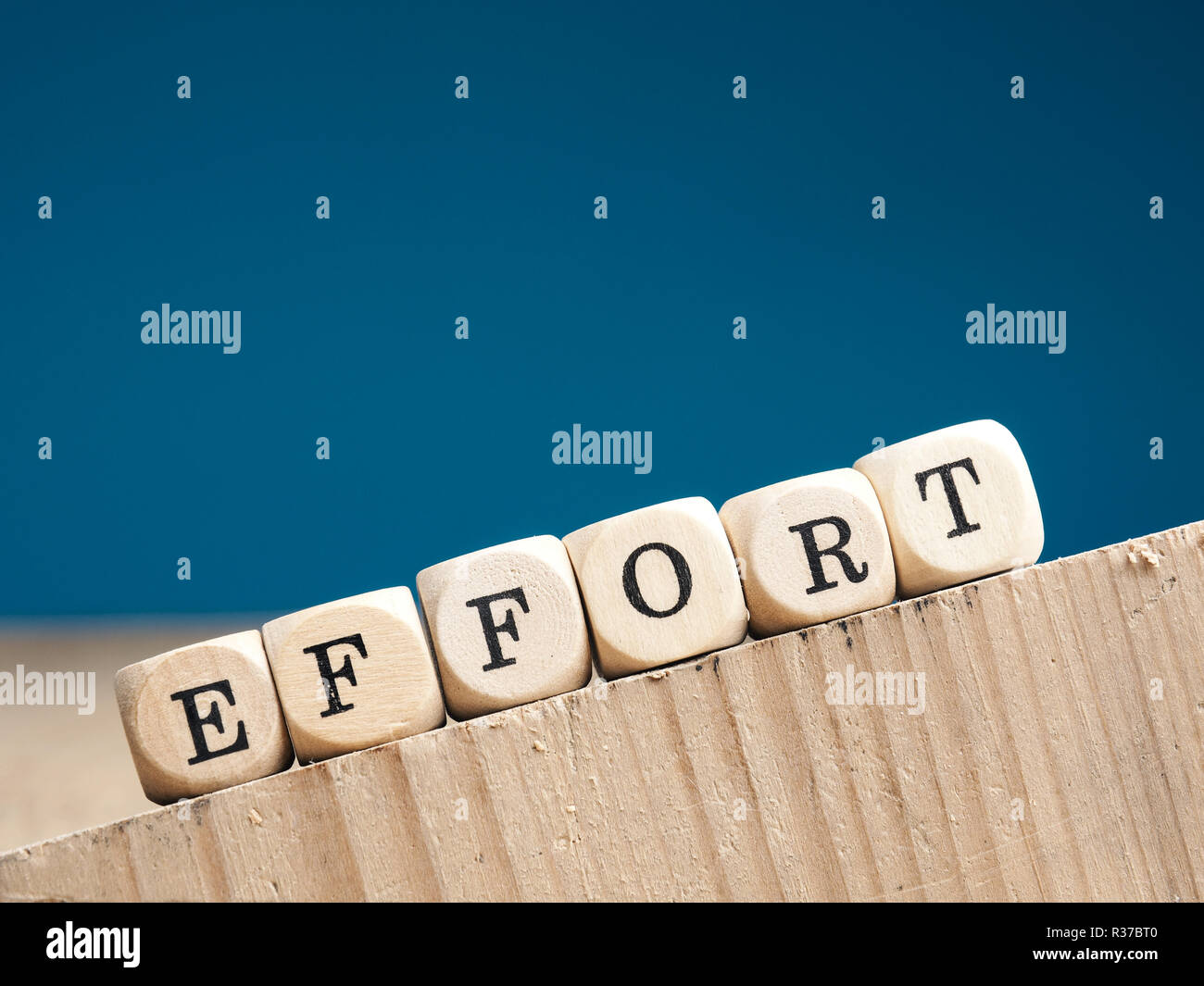 Small wooden dices with the word effort on an office table Stock Photo ...