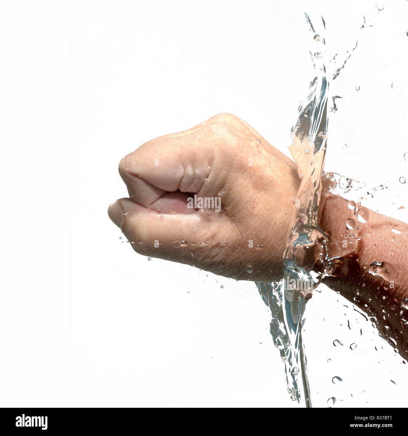 human fist beats through the water with splash, isolated on a white ...