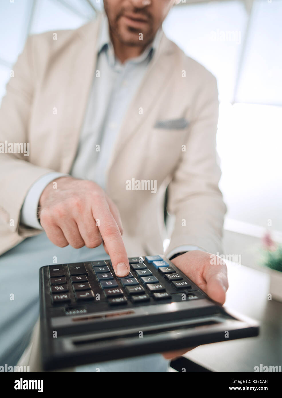 close up. businessman with calculator Stock Photo - Alamy