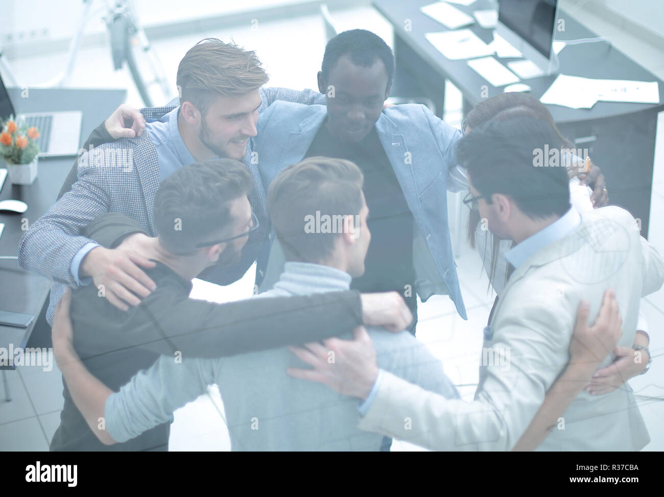 close up.business team hugging each other Stock Photo - Alamy