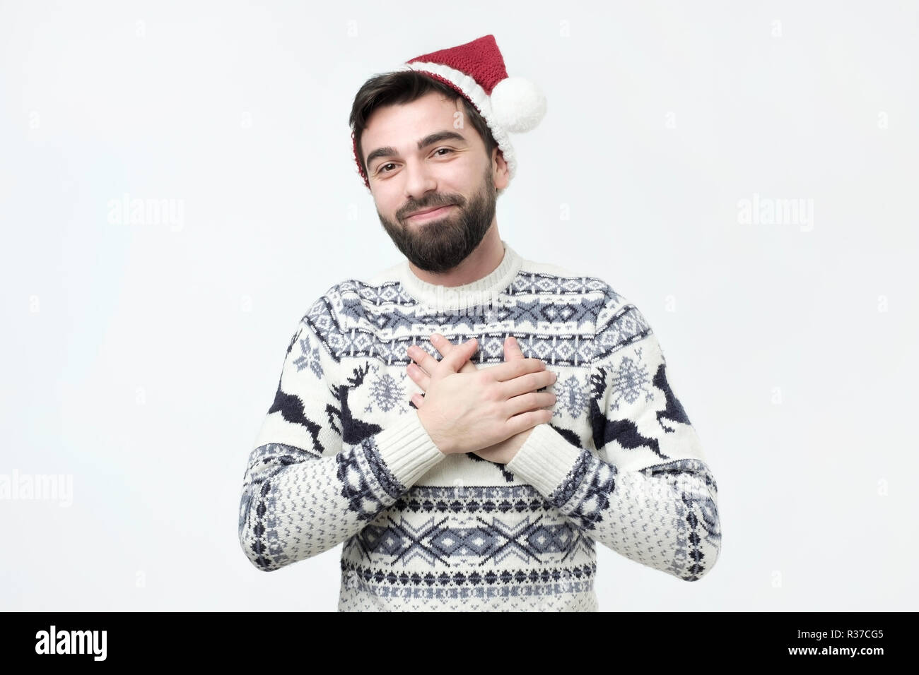 Happy friendly man in red christmas hat being content to hear ...