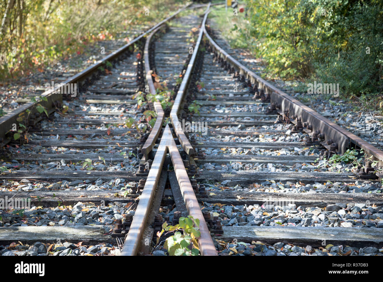two railway tracks come together with railroad switch, selected focus ...