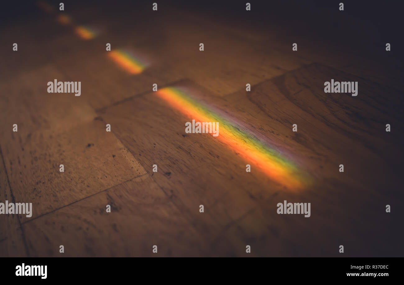 Close up photo of rainbow on wooden floor Stock Photo - Alamy