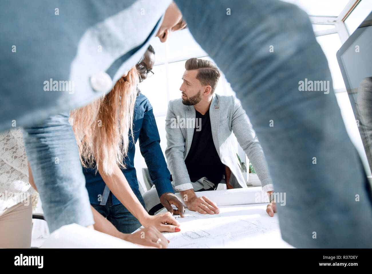 close up. a group of designers standing around the desktop Stock Photo ...