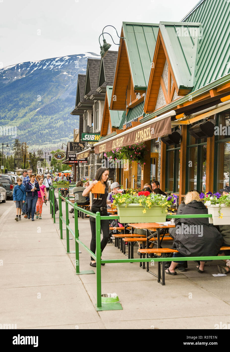 JASPER, AB, CANADA - JUNE 2018: Person serving people dining outside a ...