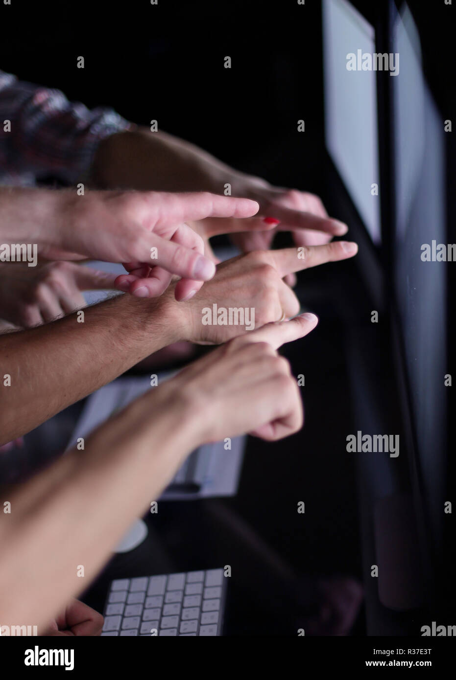 business team pointing their fingers at the computer screen Stock Photo ...