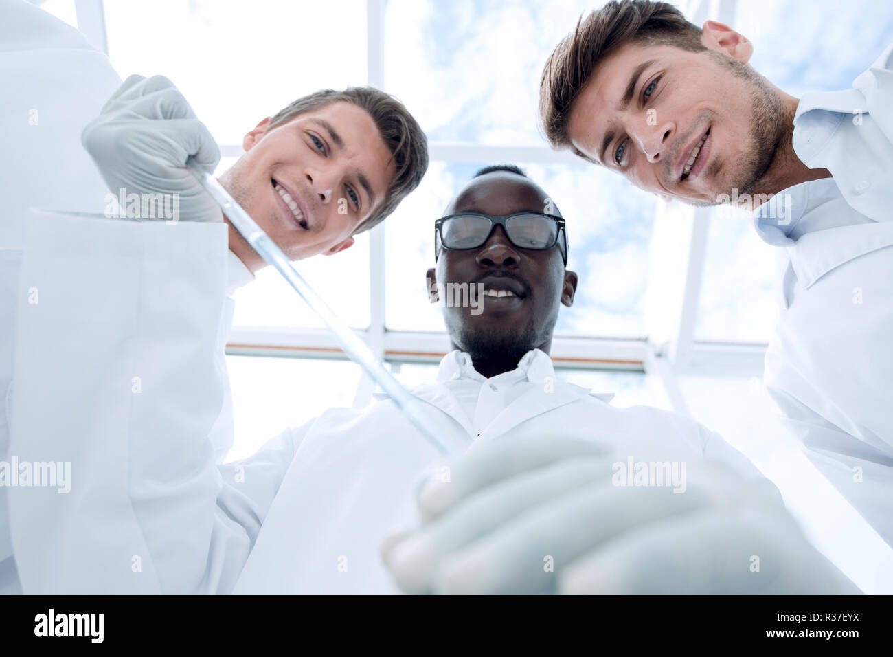 close up.a group of scientists examining liquid samples Stock Photo - Alamy