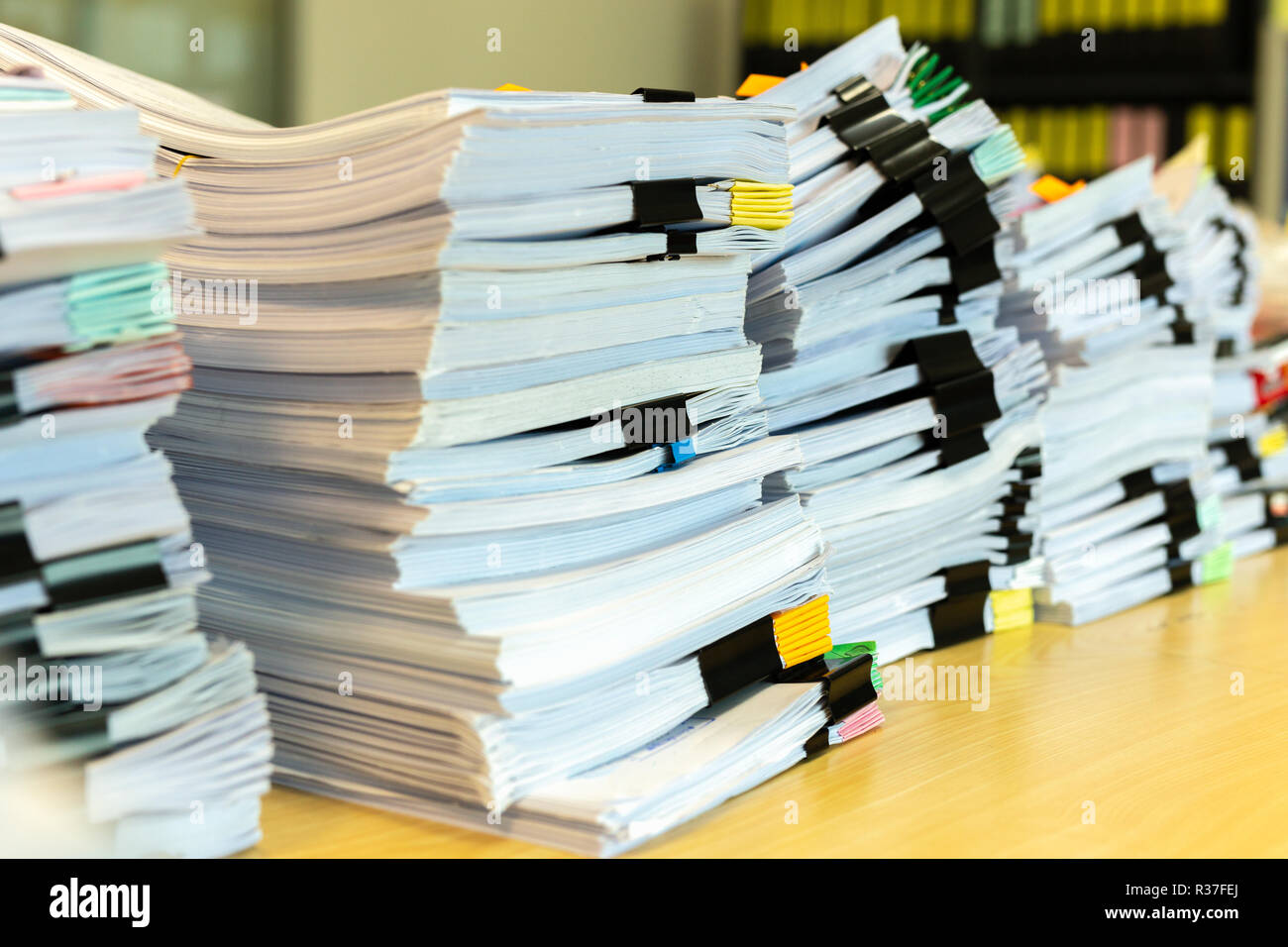 Pile of unfinished documents on office desk Stock Photo - Alamy