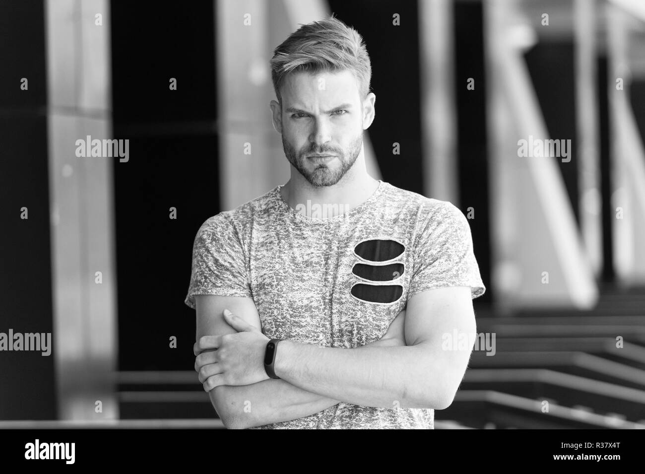 Man bristle serious face muscular shoulders, urban background ...