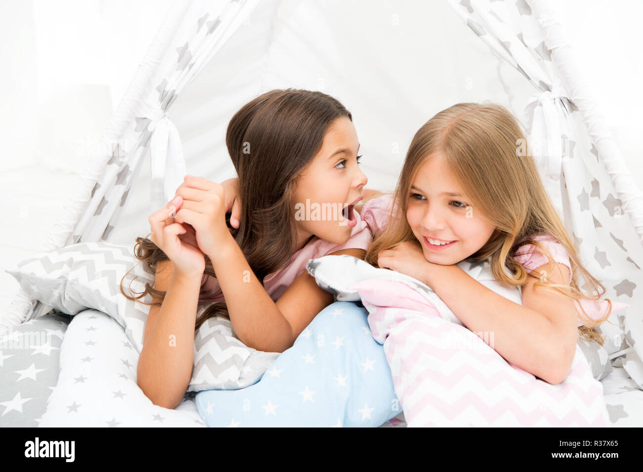 Girlish leisure. Sisters share gossips having fun at home. Pajamas ...