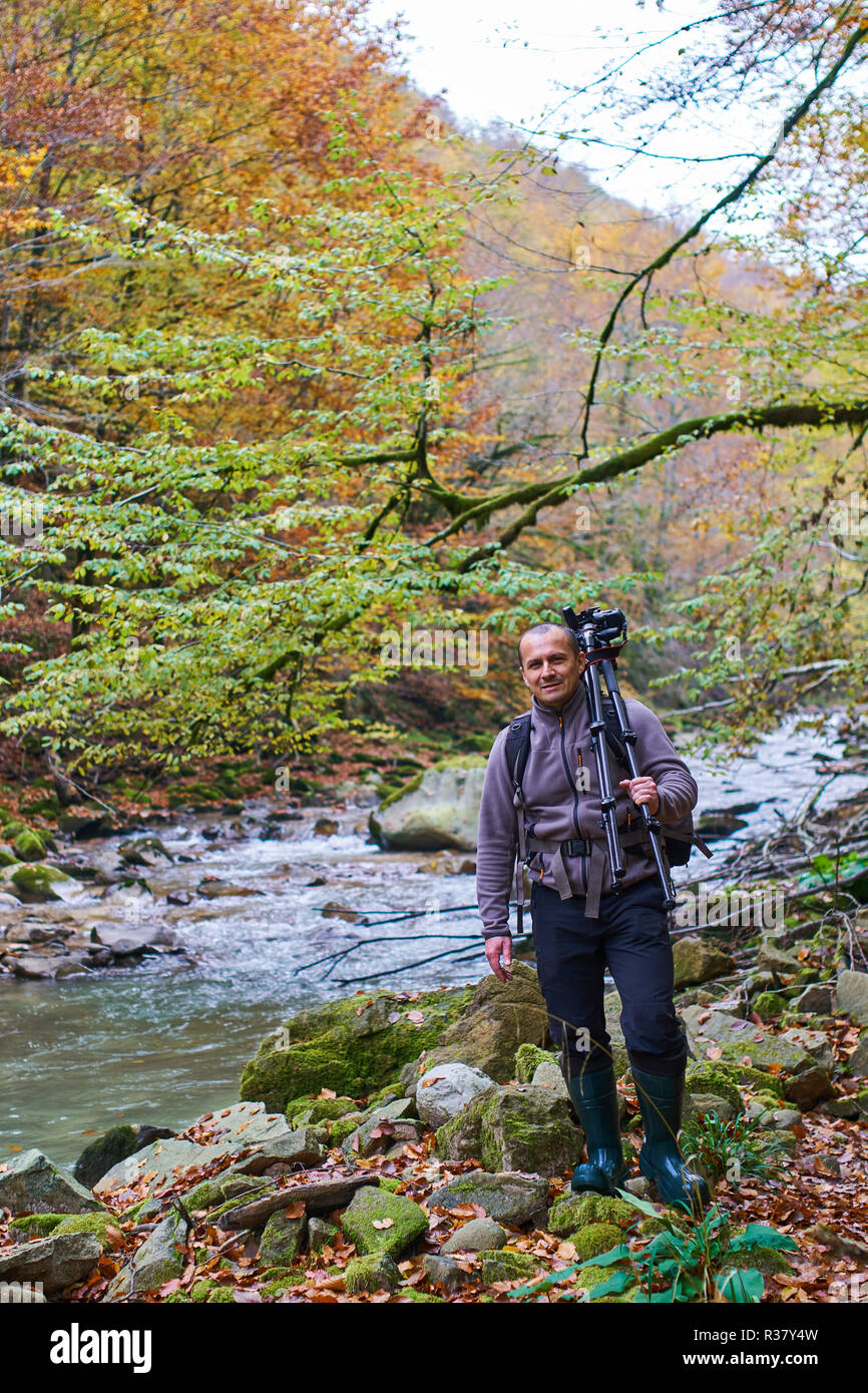 Professional nature photographer in a canyon by the river Stock Photo ...