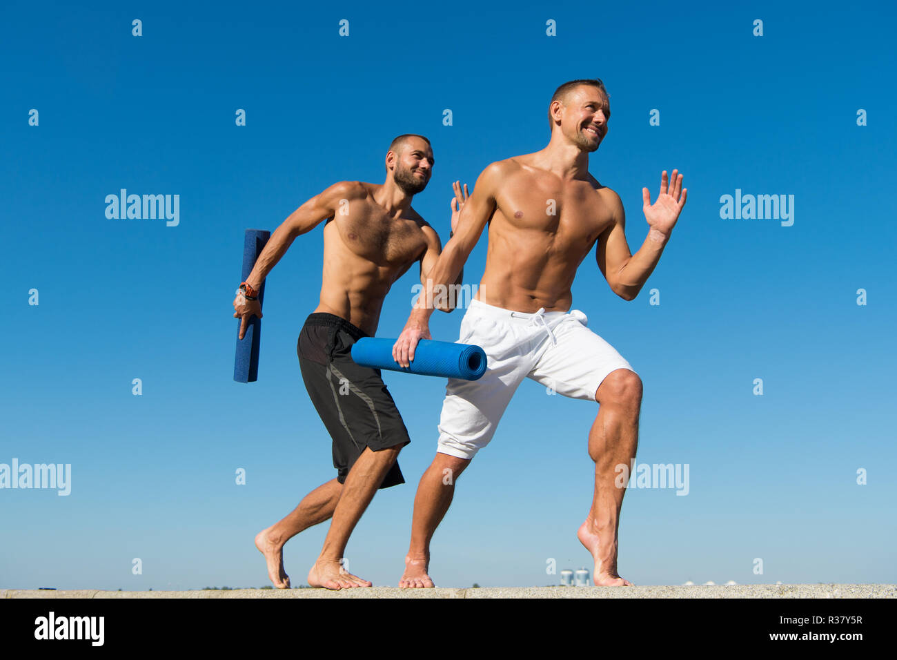 Enhancing the benefit of health activities. Muscular men do sport. Men ...