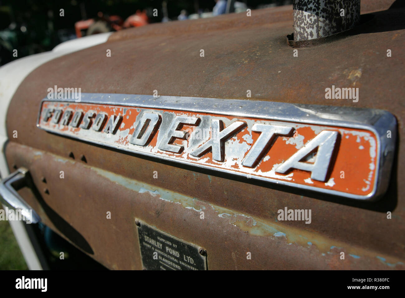 Fordson Dexta tractor and emblem on display at a country fair. England ...