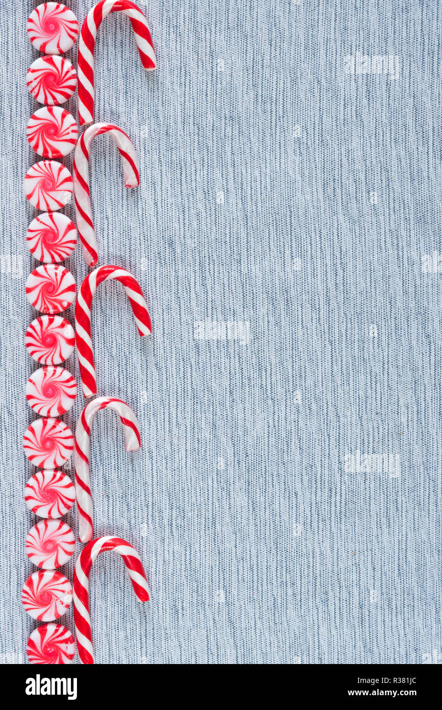 Row of candy canes and peppermint swirl candies flat lay border Stock ...
