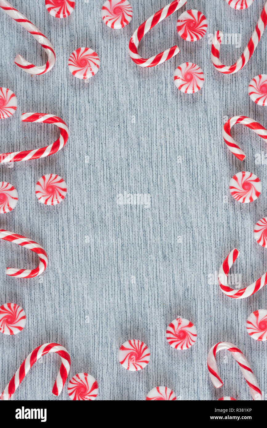 Frame of Christmas candy canes and peppermint swirl candies with copy ...