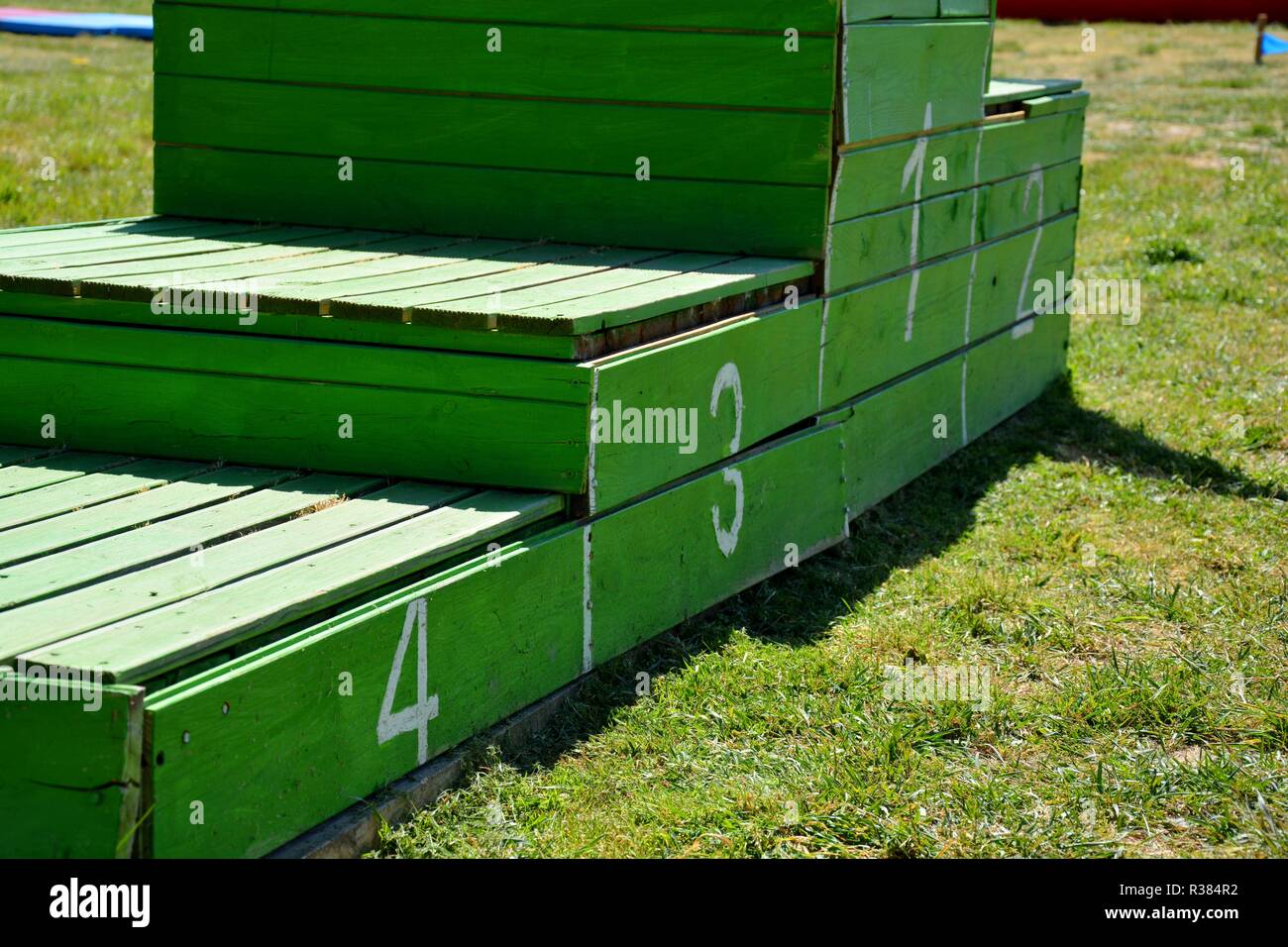 green podium with four boxes Stock Photo - Alamy