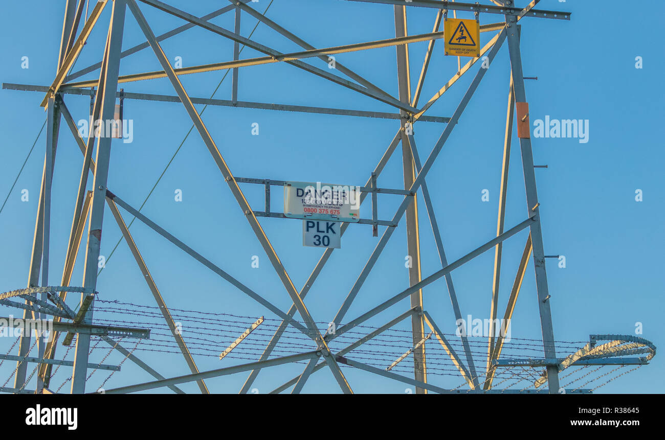 A metal electricity pylon (UK) showing danger signs. Also known as a ...