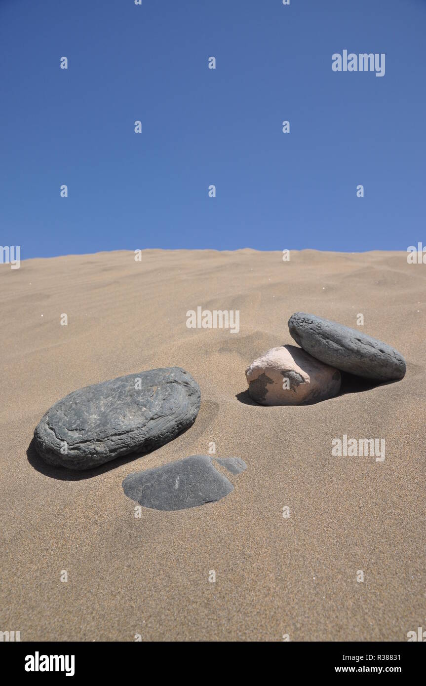 stones in sand Stock Photo - Alamy