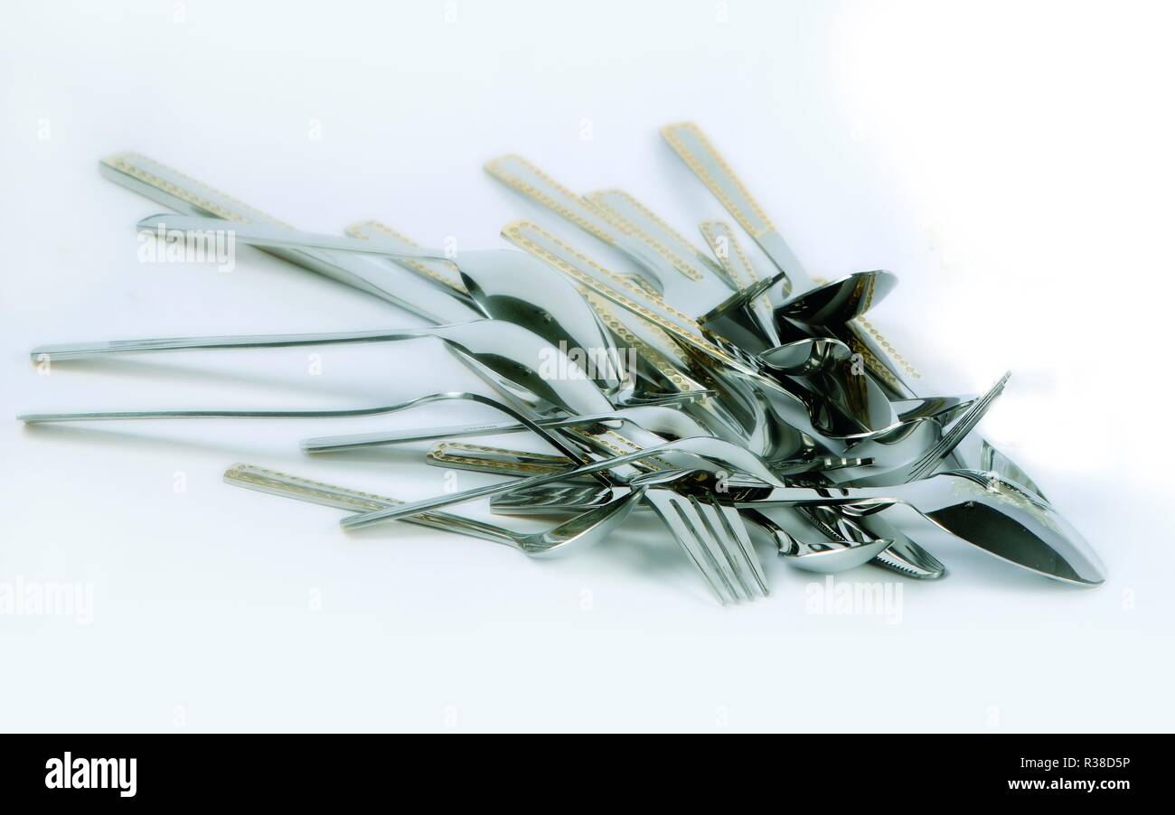 Many different sized spoons and forks on a pile Stock Photo - Alamy