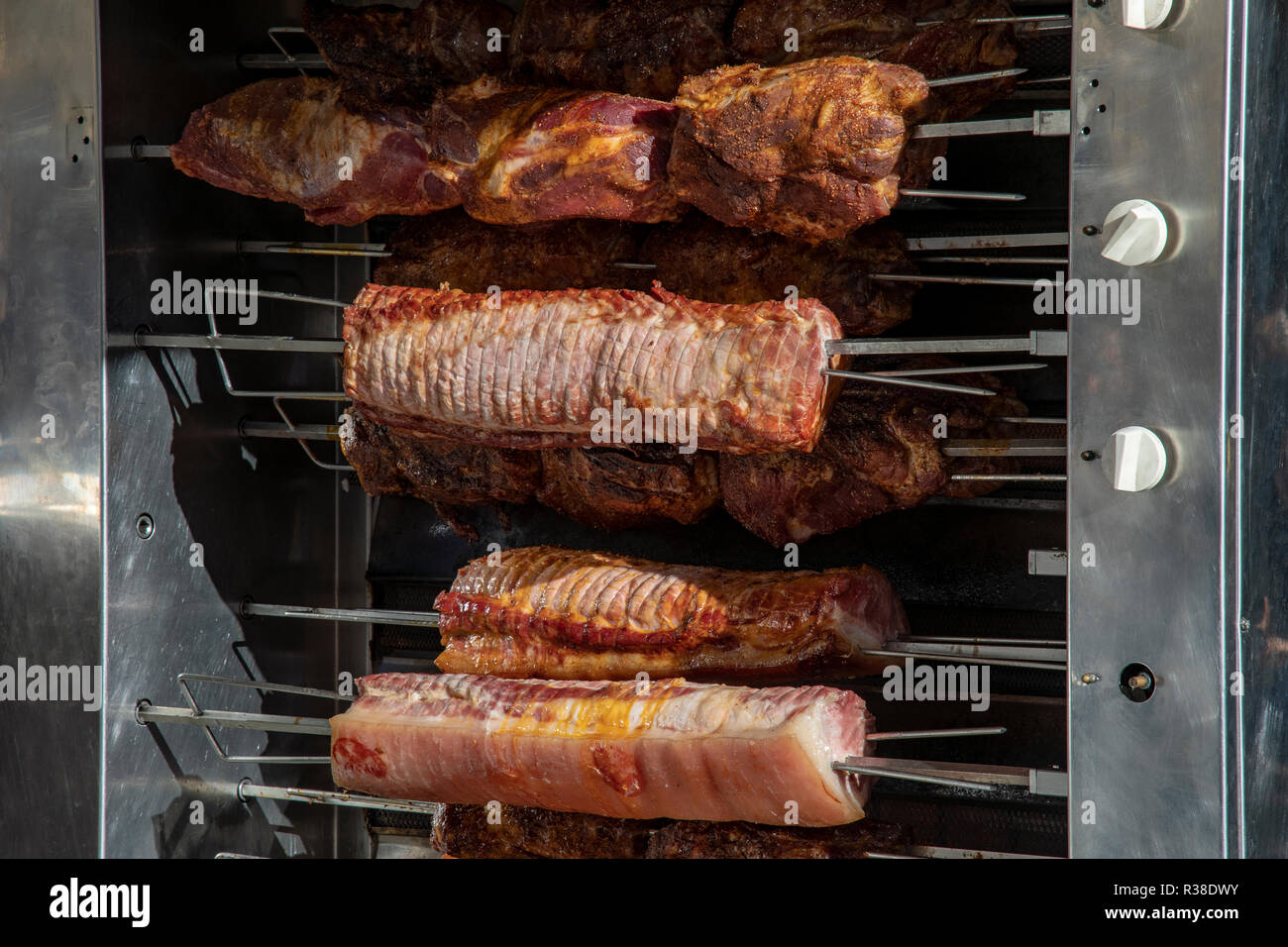 barbeque with roll ham and prok in a big grill on the market Stock ...