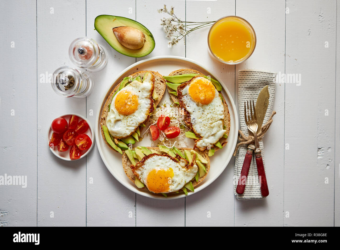 Delicious healthy breakfast with sliced avocado sandwiches with fried ...