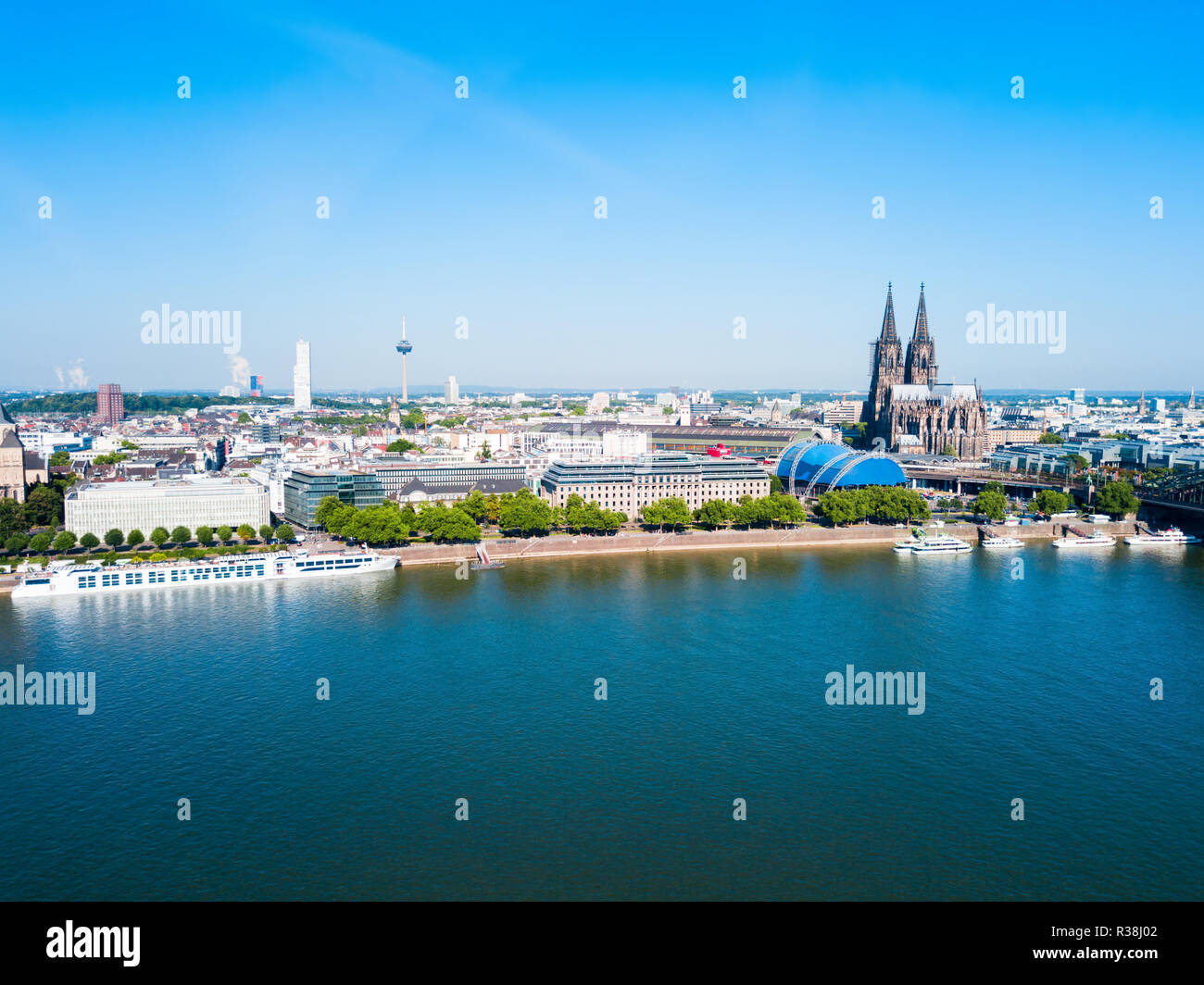 Cologne Cathedral and Hohenzollern Bridge through Rhine river in ...