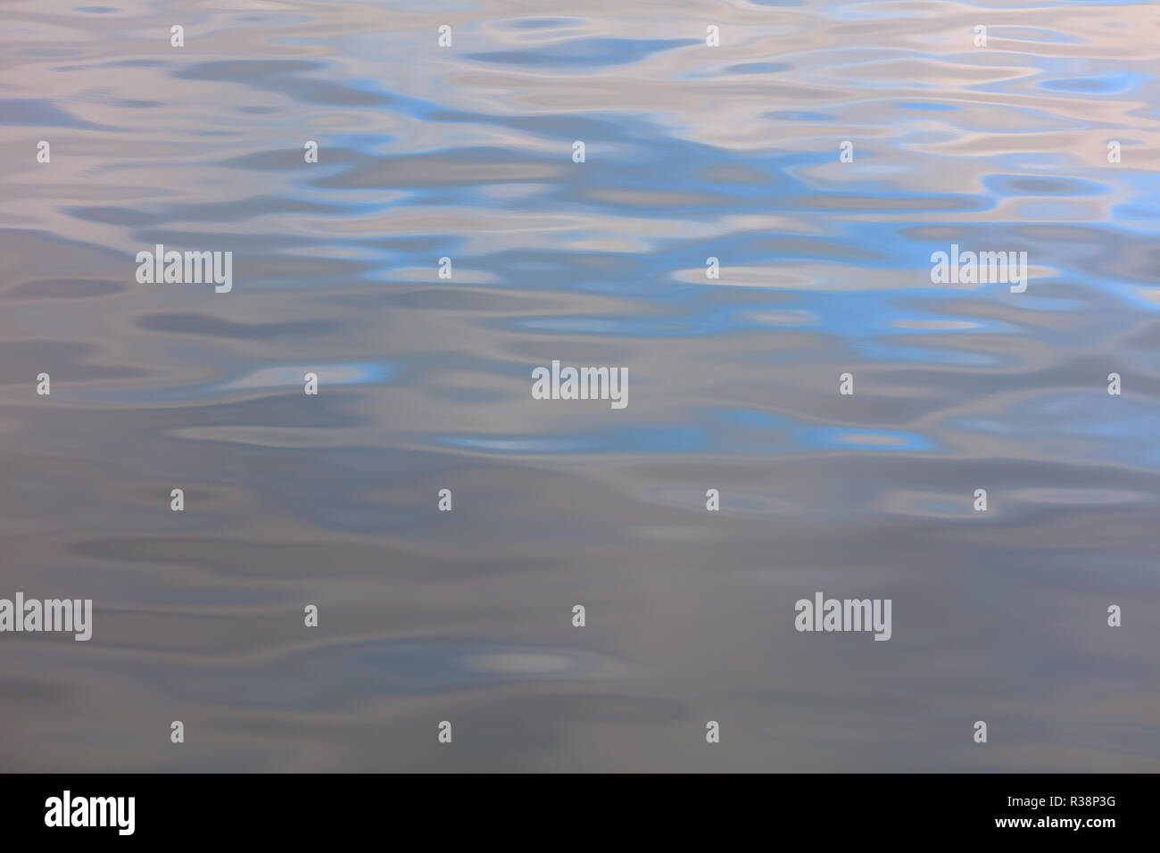 Water surface of a very calm Baltic Sea reflecting different colors ...