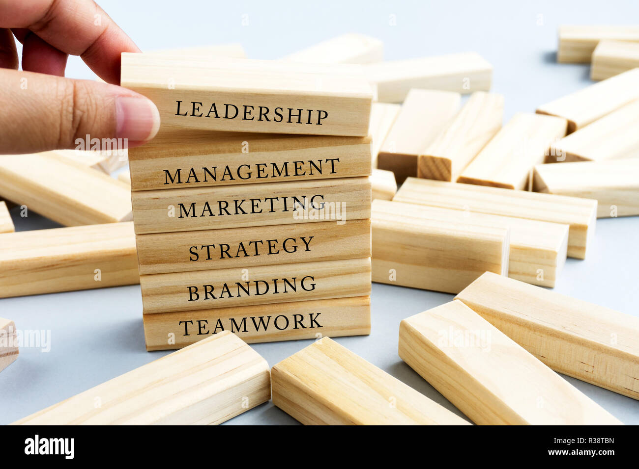 Hand Picking Wood Block with Word Leadership. Business Concept - Wood ...