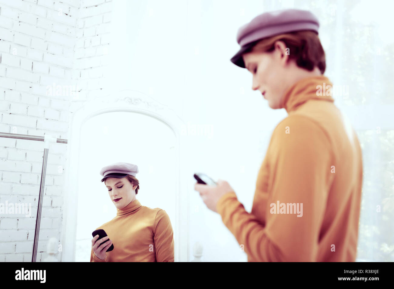 Handsome queer young boy texting with his smartphone Stock Photo - Alamy