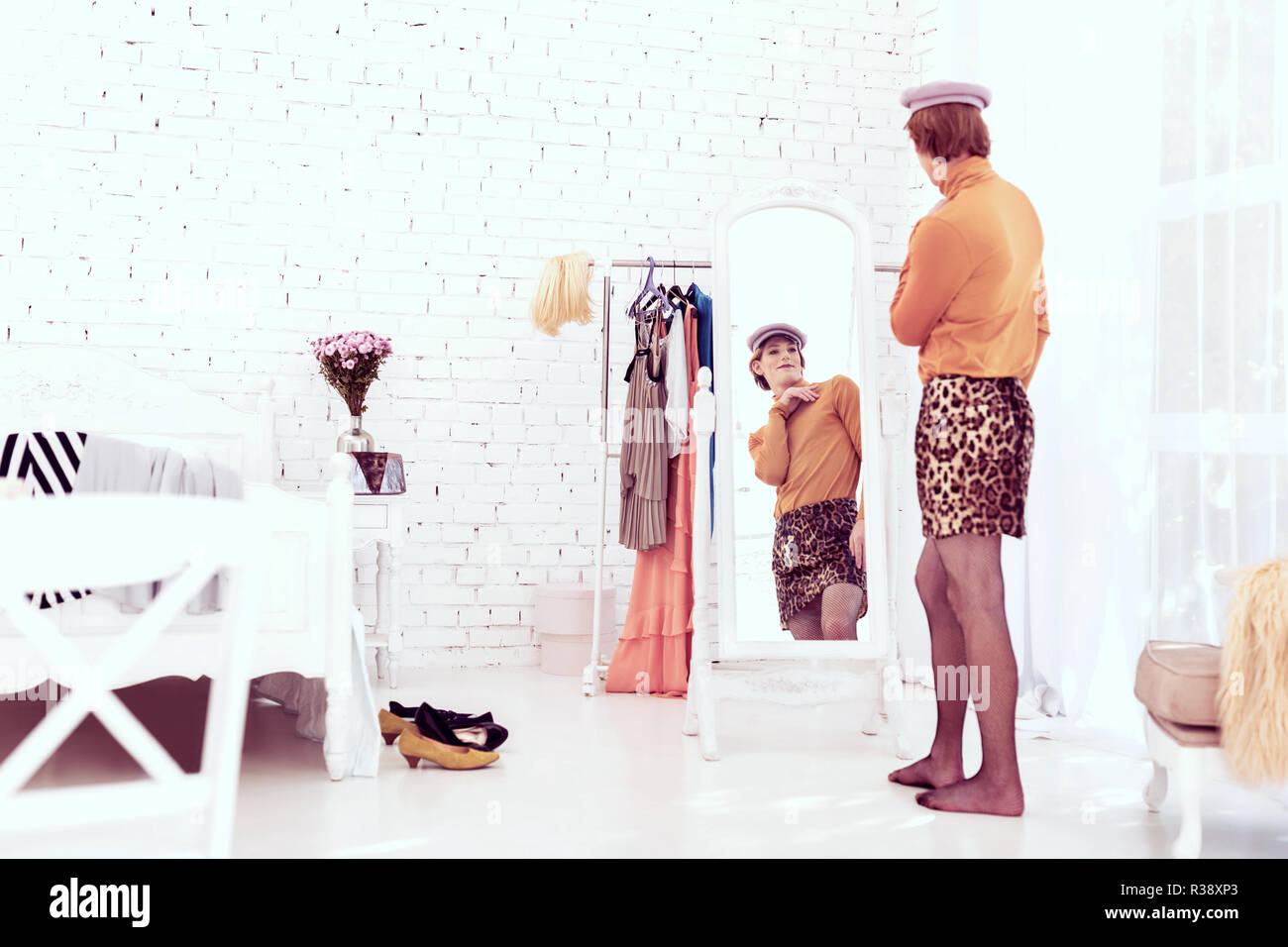 Attractive young man staying in his room full of fashion pieces Stock ...