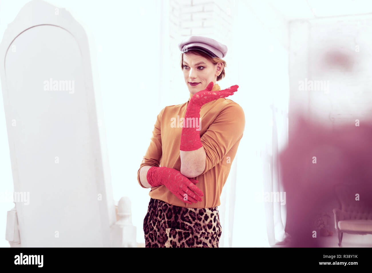 Interesting bright transgender weirdly posing at home Stock Photo - Alamy