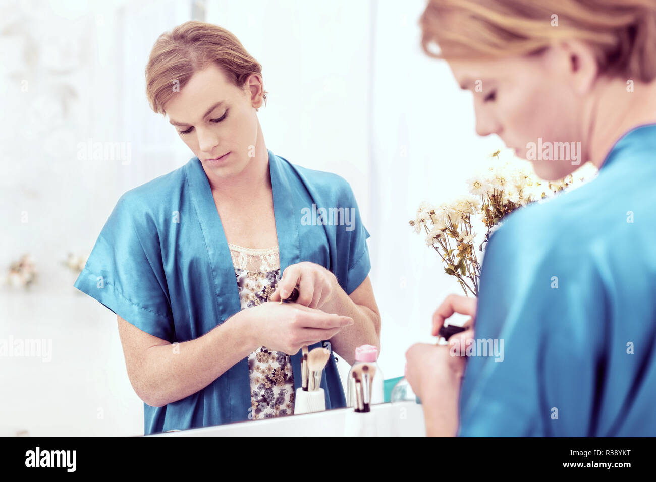 Beautiful ginger transgender man getting ready for date night Stock ...