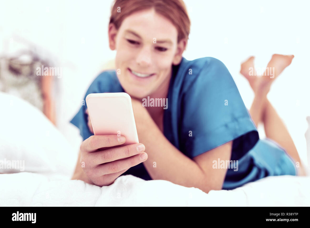 Cheerful short-haired transgender spending time with his mobile phone ...